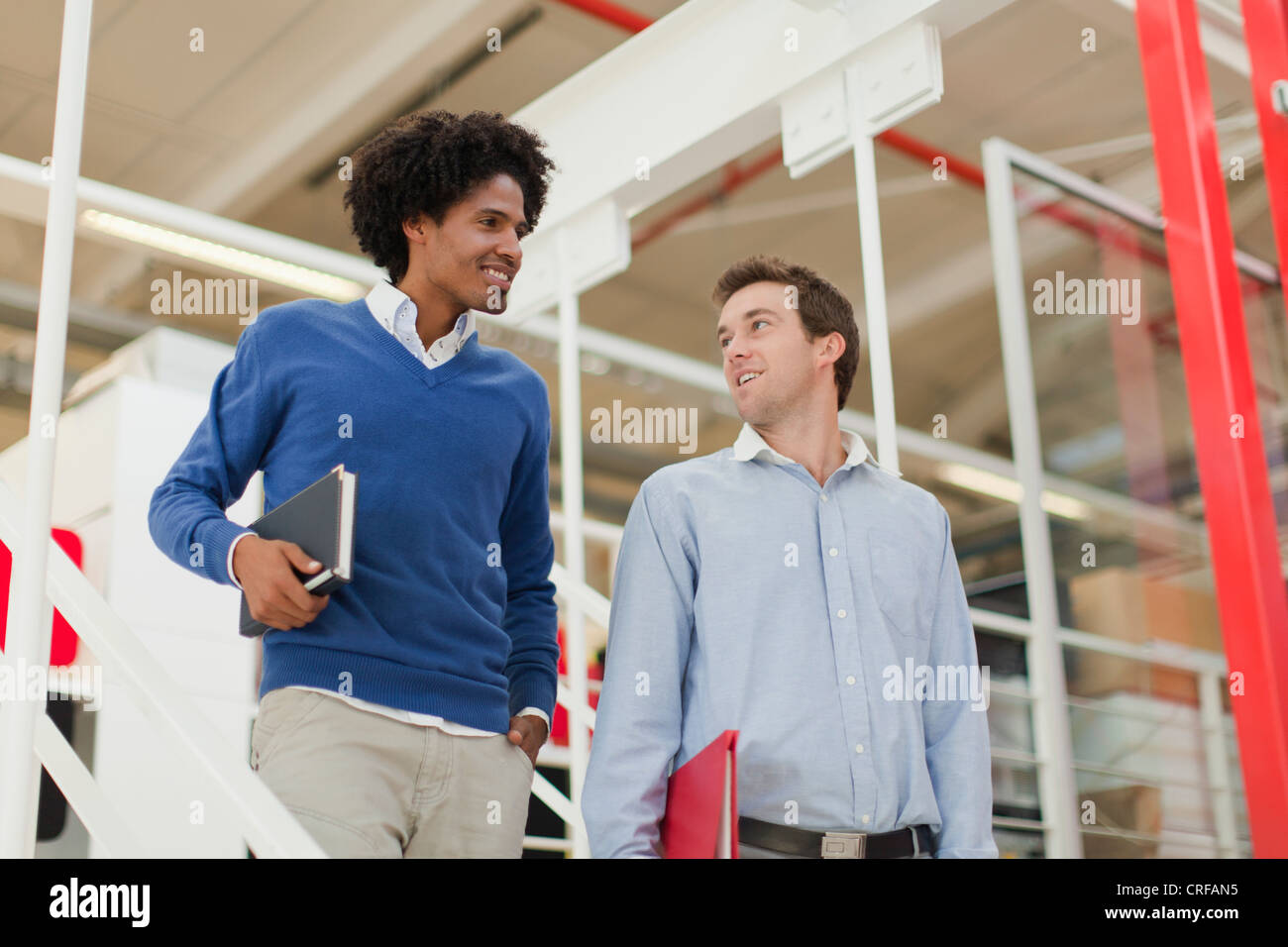 Businessmen walking together in office Stock Photo - Alamy