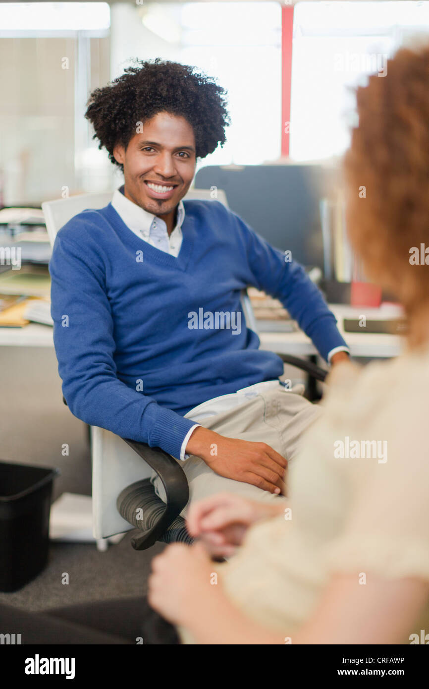 Business people talking at desks Stock Photo - Alamy