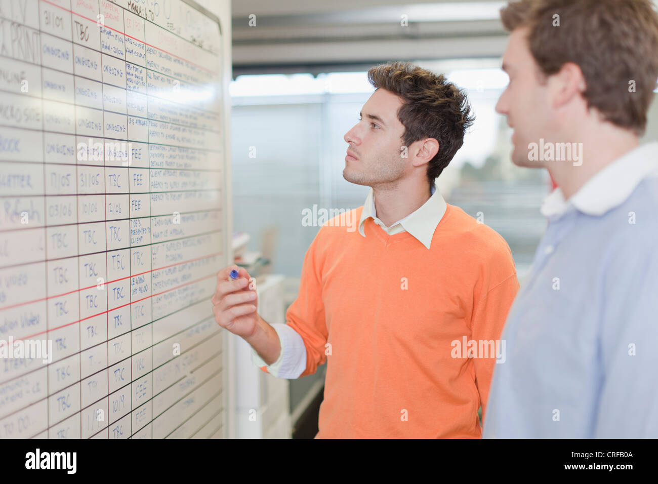 Businessman writing on whiteboard Stock Photo - Alamy