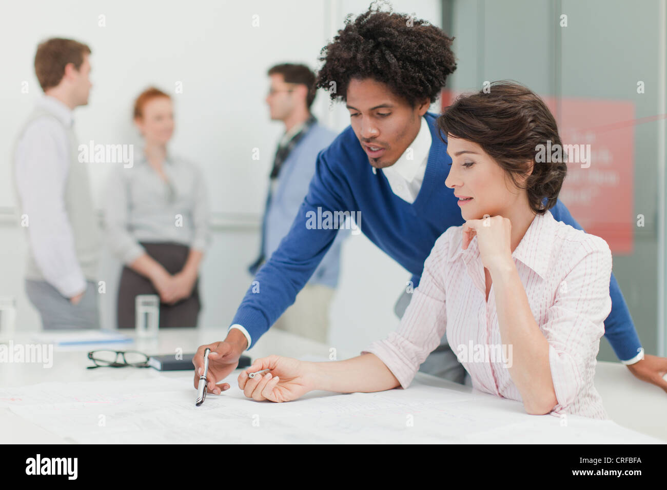 Business people reading in meeting Stock Photo - Alamy