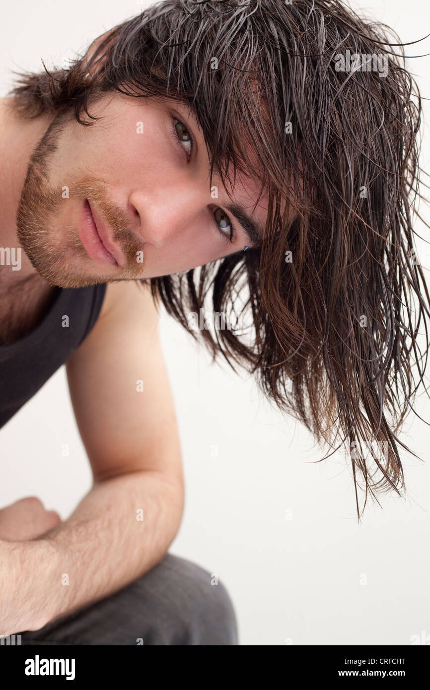 Portrait of a handsome young man with long hair Stock Photo - Alamy