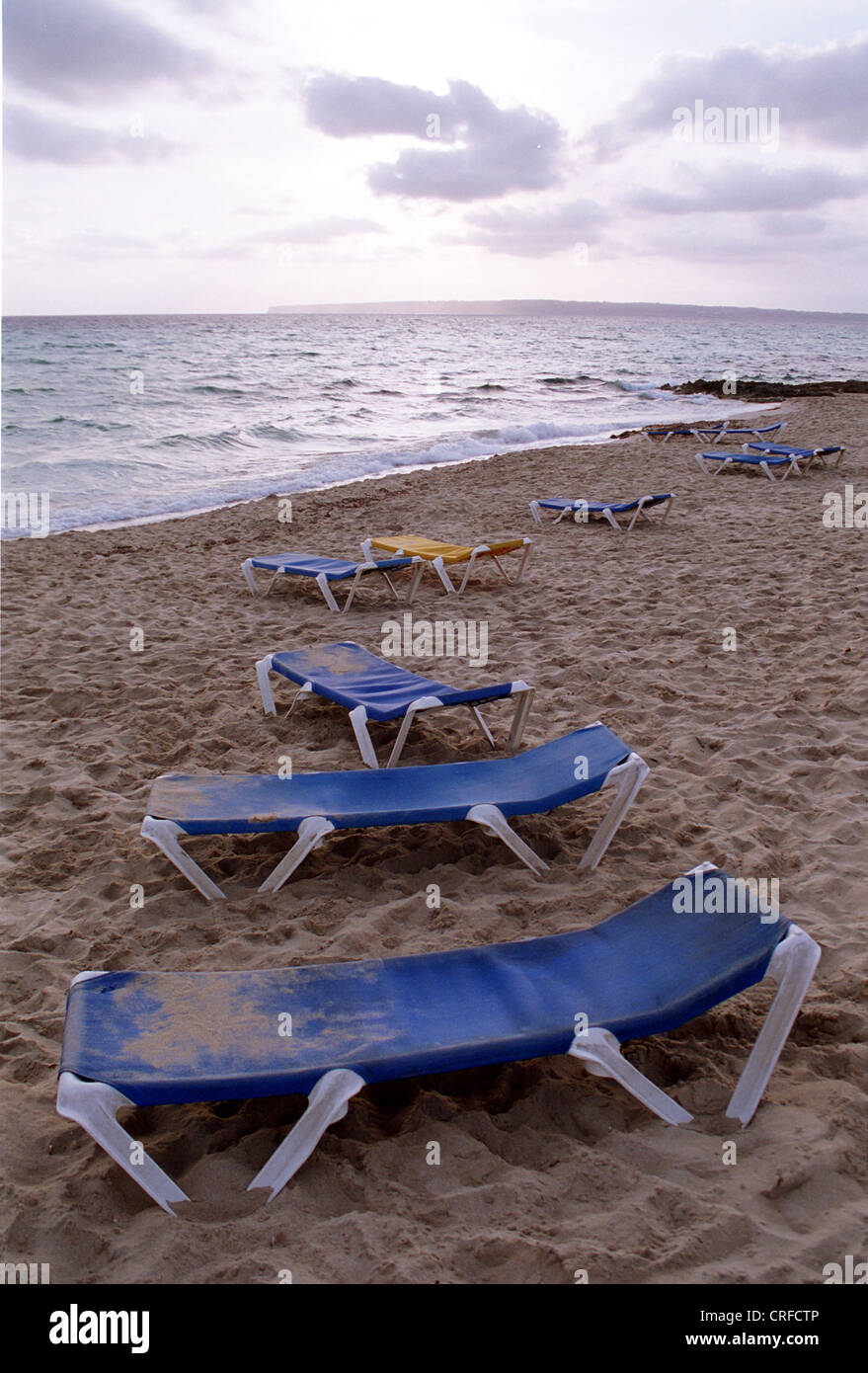 Es Calo, Spain, beach landscape with empty sunbeds Stock Photo - Alamy