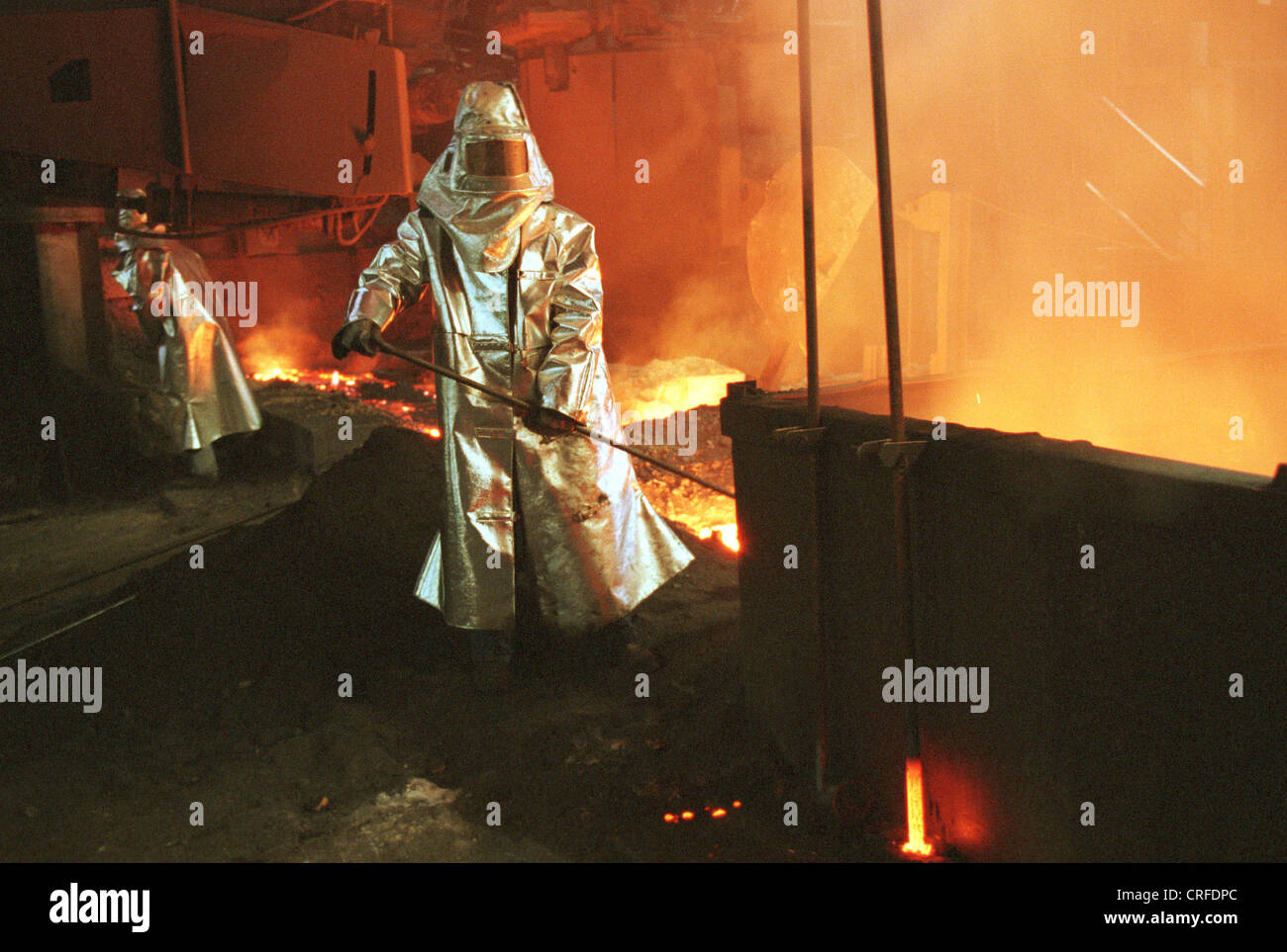 Eisenhuettenstadt, Germany, steel workers check the pig iron during ...