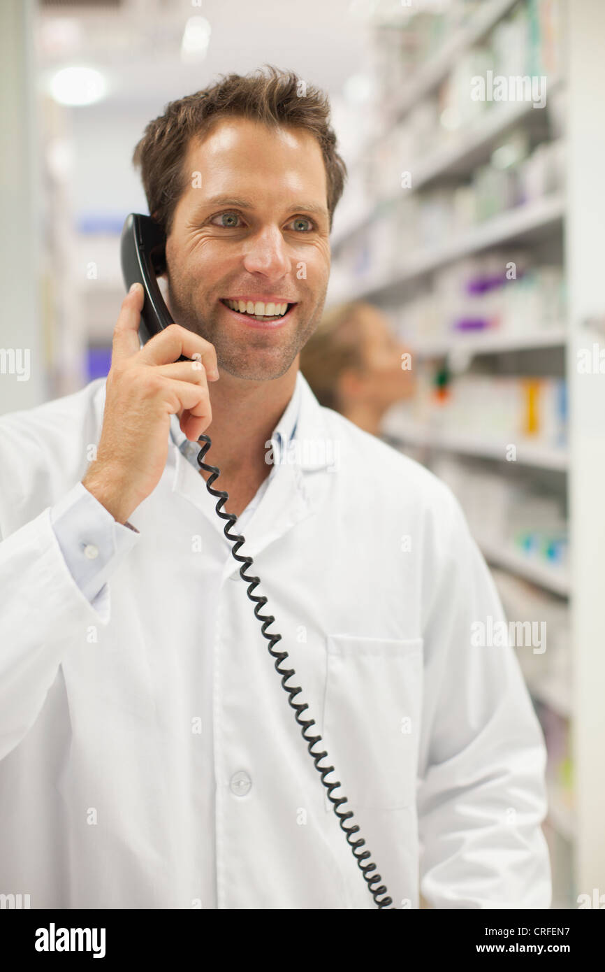 Pharmacist talking on phone Stock Photo - Alamy