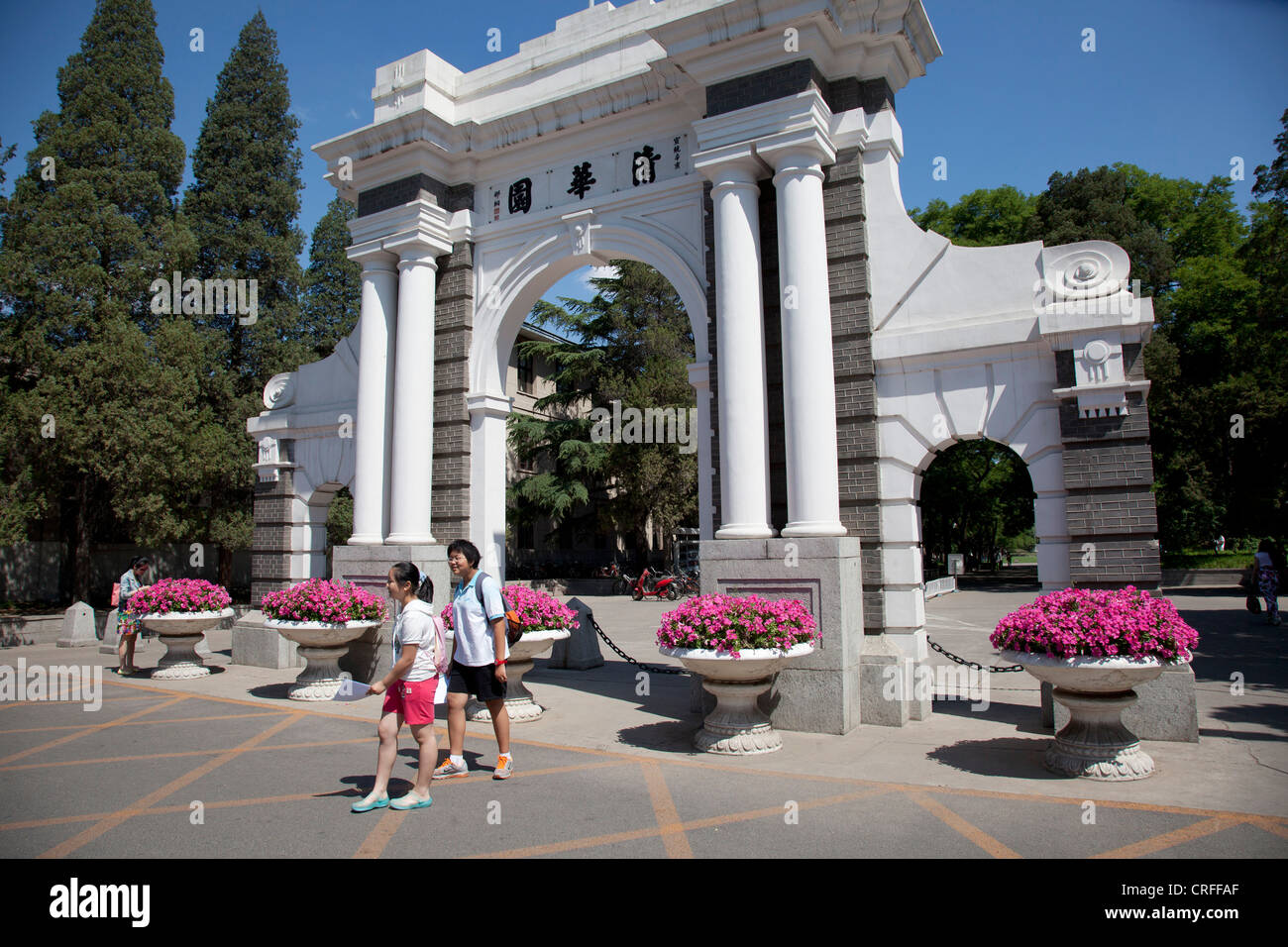 Students pass by The Old Gate on campus at Tsinghua University in ...
