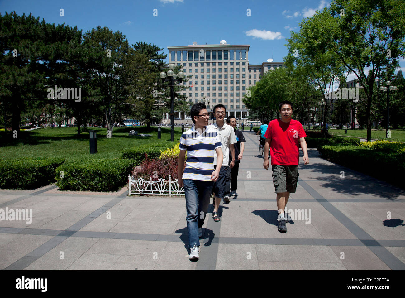 Students walking past the central main building on campus at Tsinghua ...