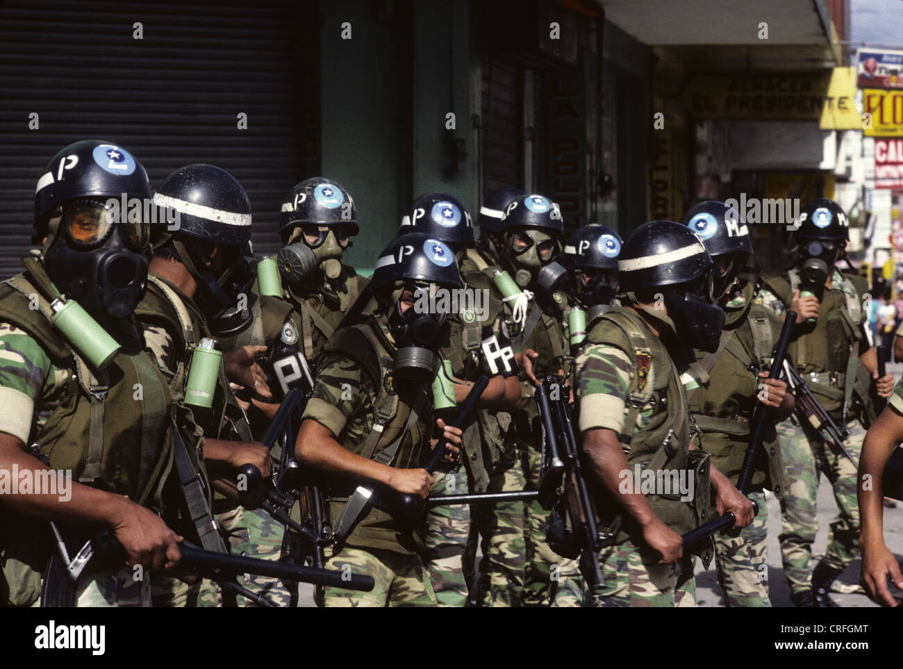 Guatemala 1985.Army on the streets with tear gas, gas masks and batons ...
