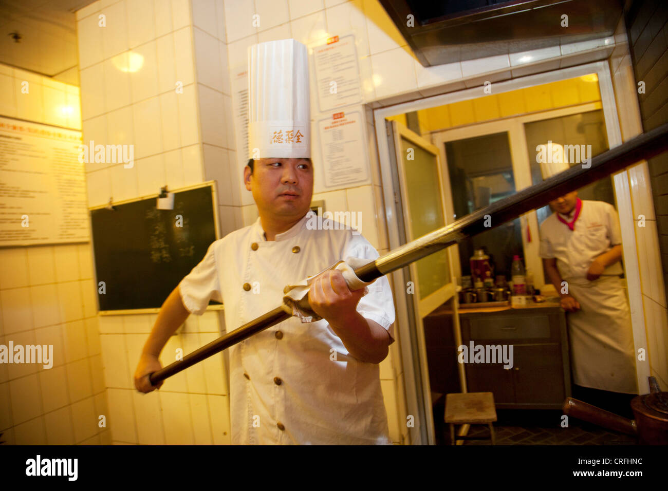 Duck chef lifts ducks in and out of the ovens. Quanjude roast duck ...