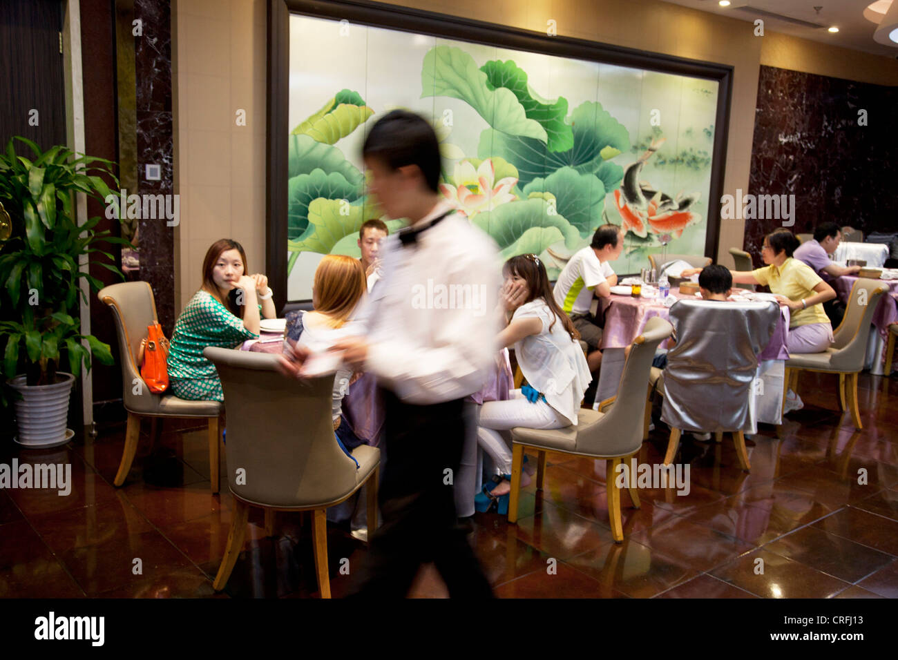 Waiting staff and customers in the main dining room. Quanjude roast ...
