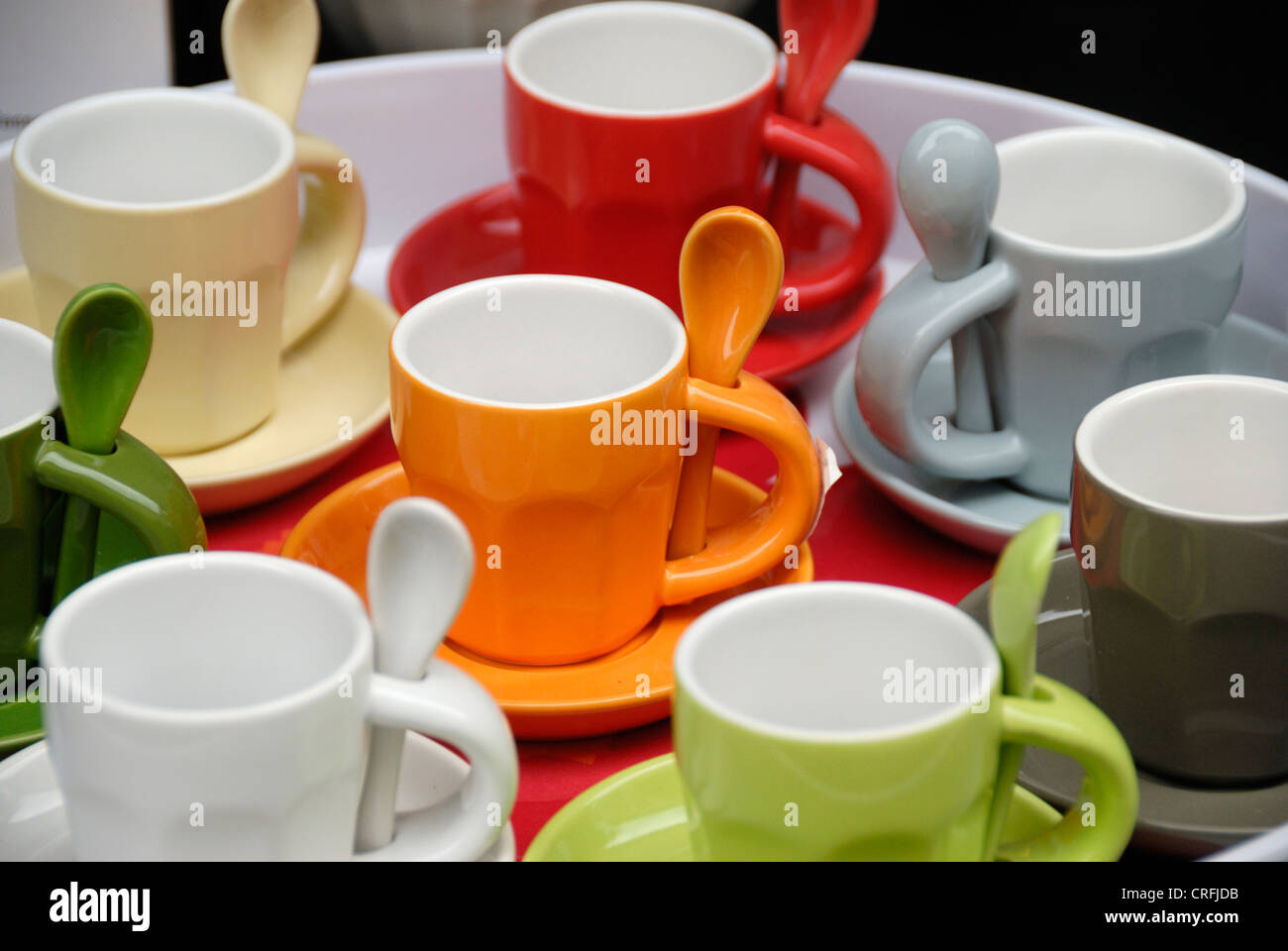 Coloured cups and sauces with matching built-in teaspoons Stock Photo ...