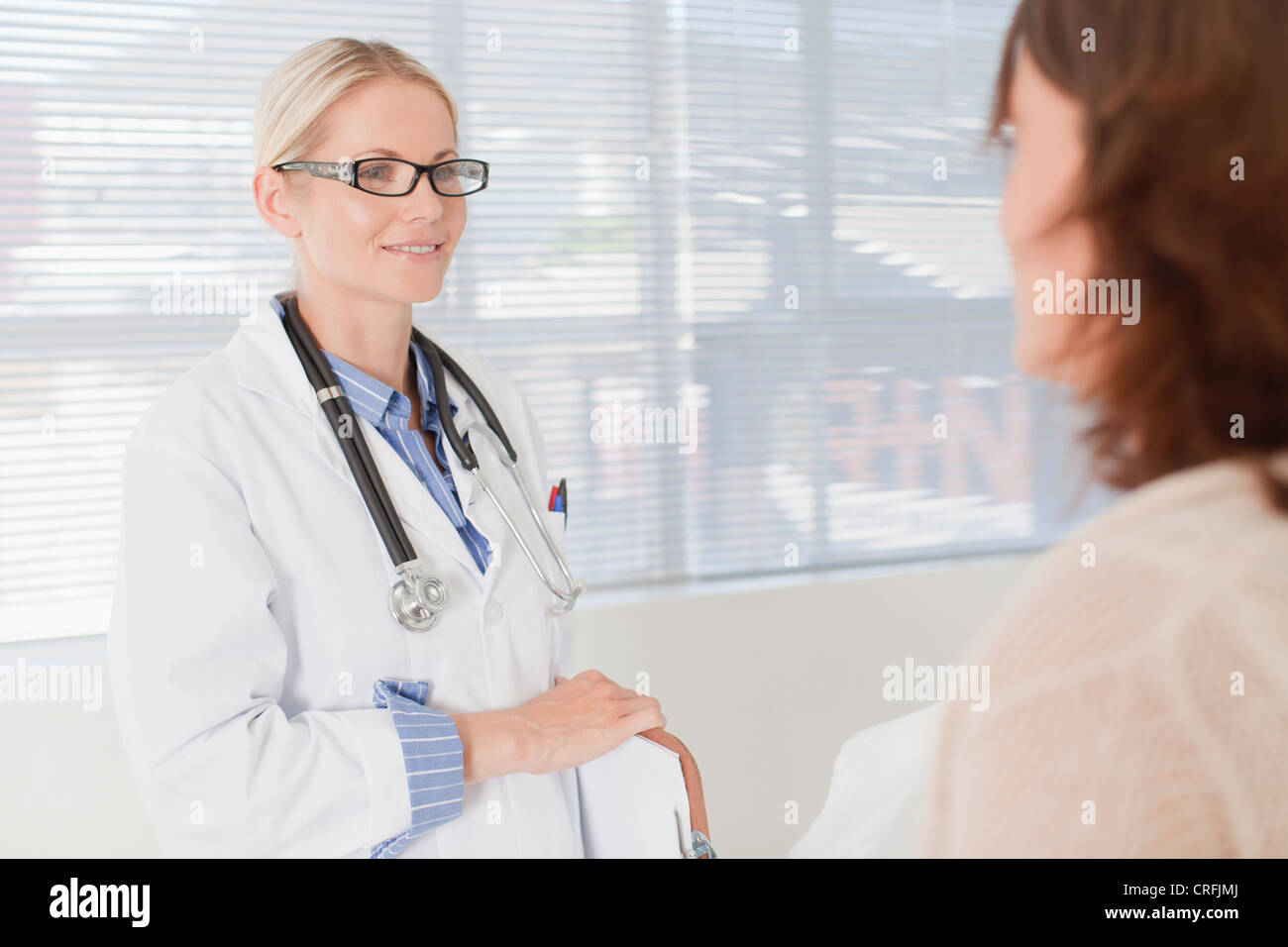 Doctor and patient talking in office Stock Photo - Alamy