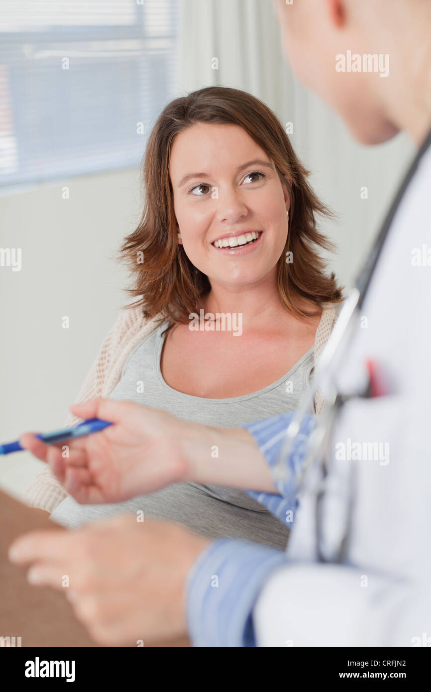 Doctor and patient talking in office Stock Photo - Alamy