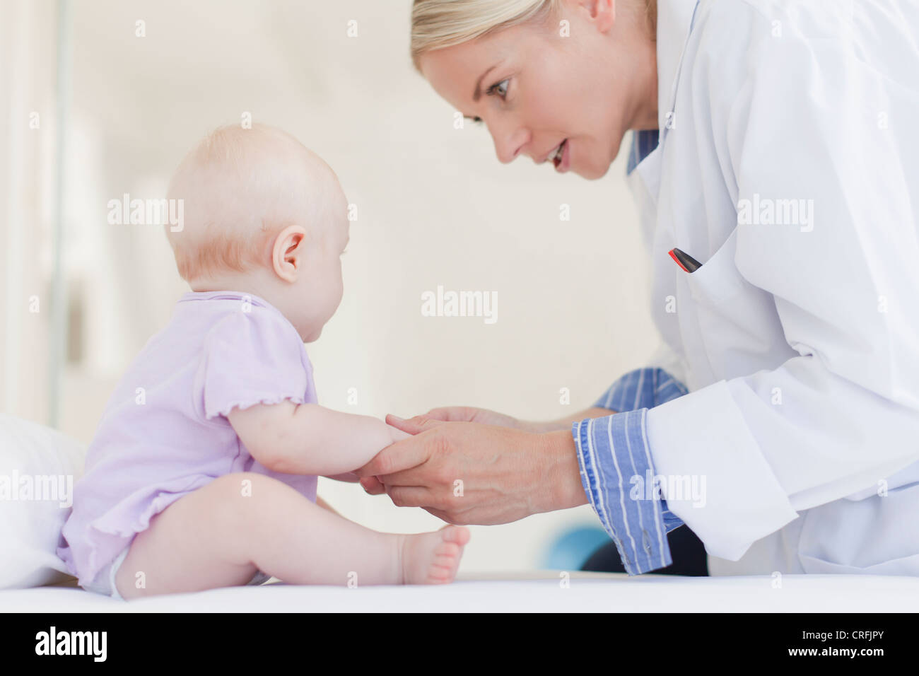 Doctor examining baby in office Stock Photo - Alamy