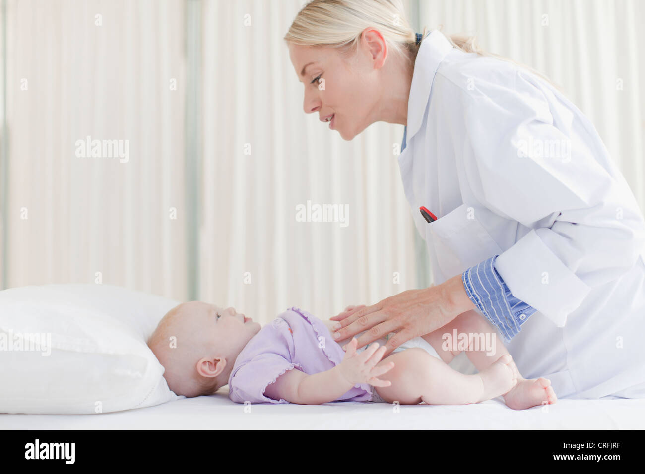 Doctor comforting baby hi-res stock photography and images - Alamy