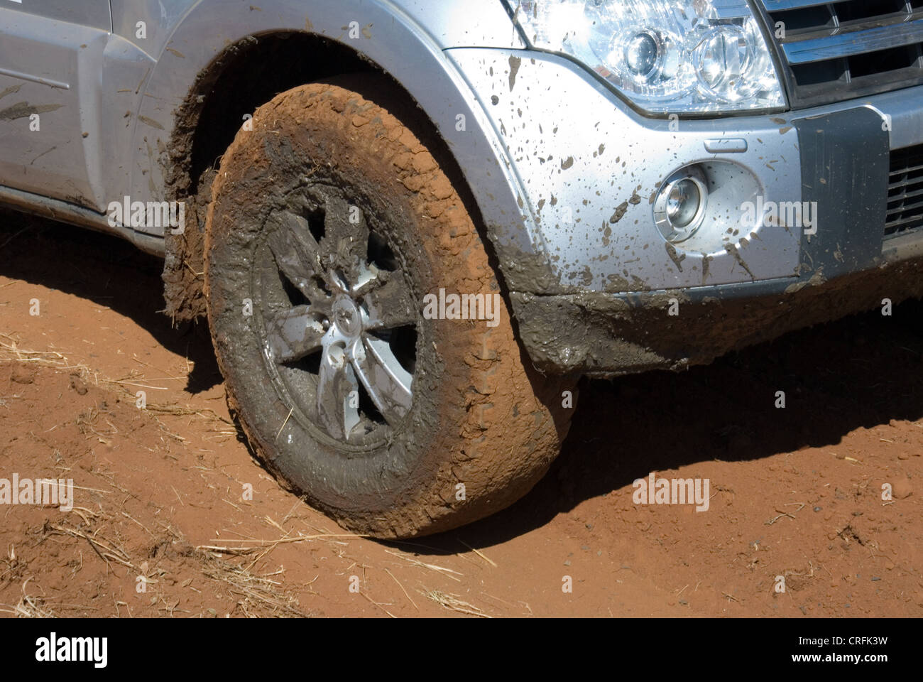 Close up of a 4x4 vehicle with tyres full of mud Stock Photo - Alamy