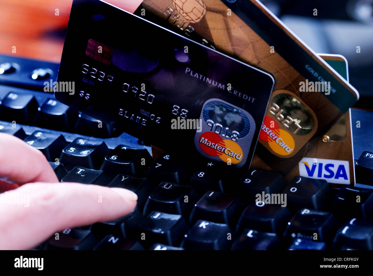 Computer keyboard with hand and credit cards, on line sales Stock Photo ...