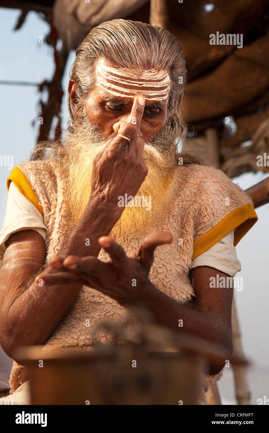 Hindu monk Sadhu show me , how to decorating himself for god, Varanasi ...