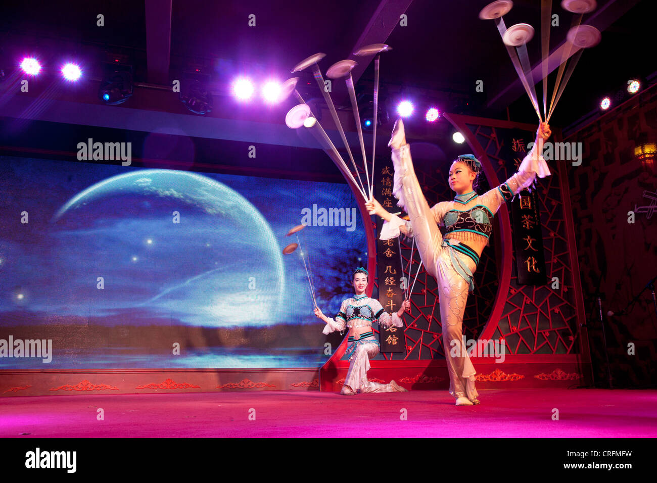 Acrobats perform a plate spinning routine in stage at Laoshe teahouse ...