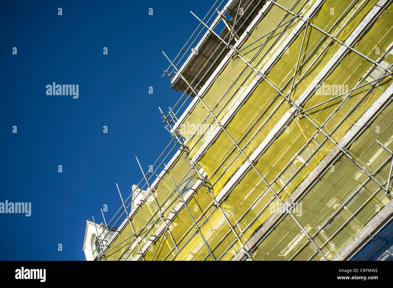 Netting covered scaffolding on the exterior of a building being ...