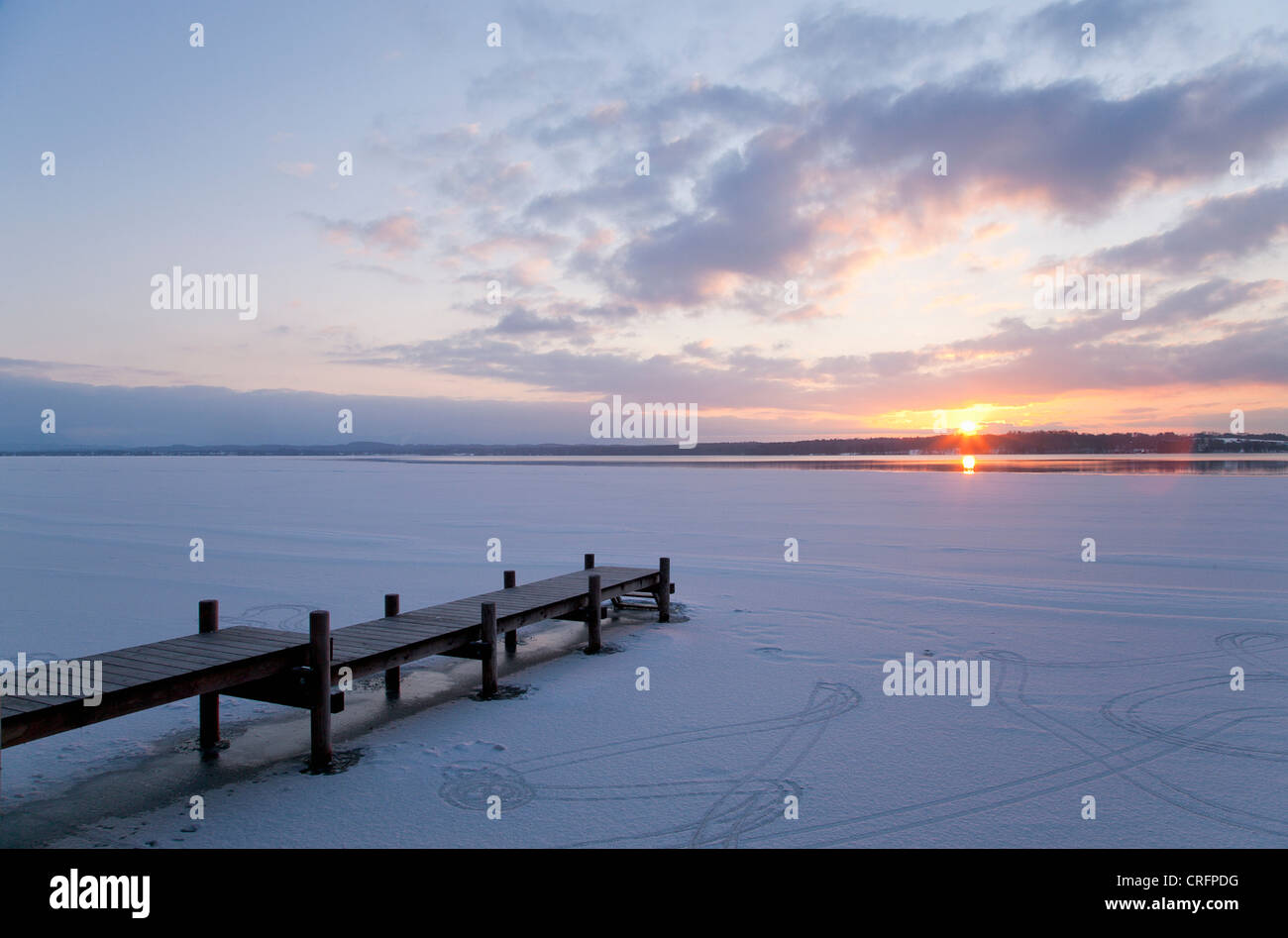 Pier jutting out into frozen lake Stock Photo - Alamy