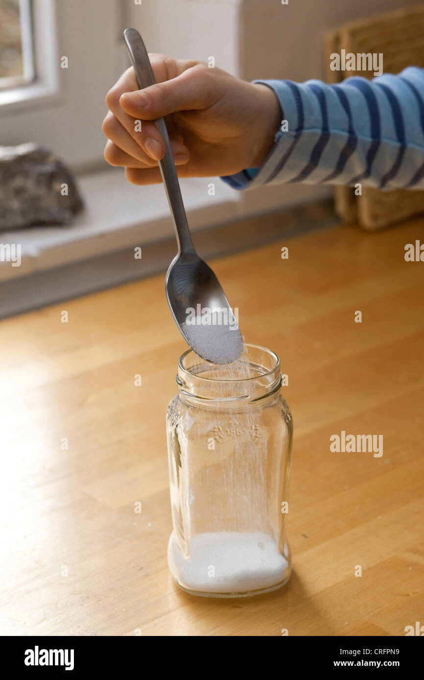 children experimenting and growing crystals. Step 1: salt filling into ...
