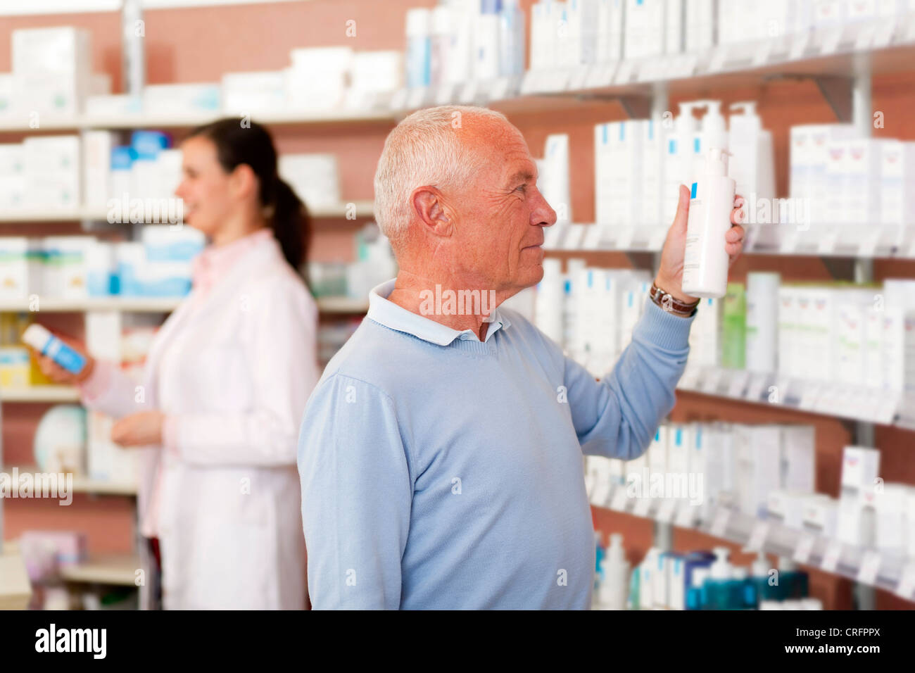 Customer browsing on drugstore shelves Stock Photo - Alamy