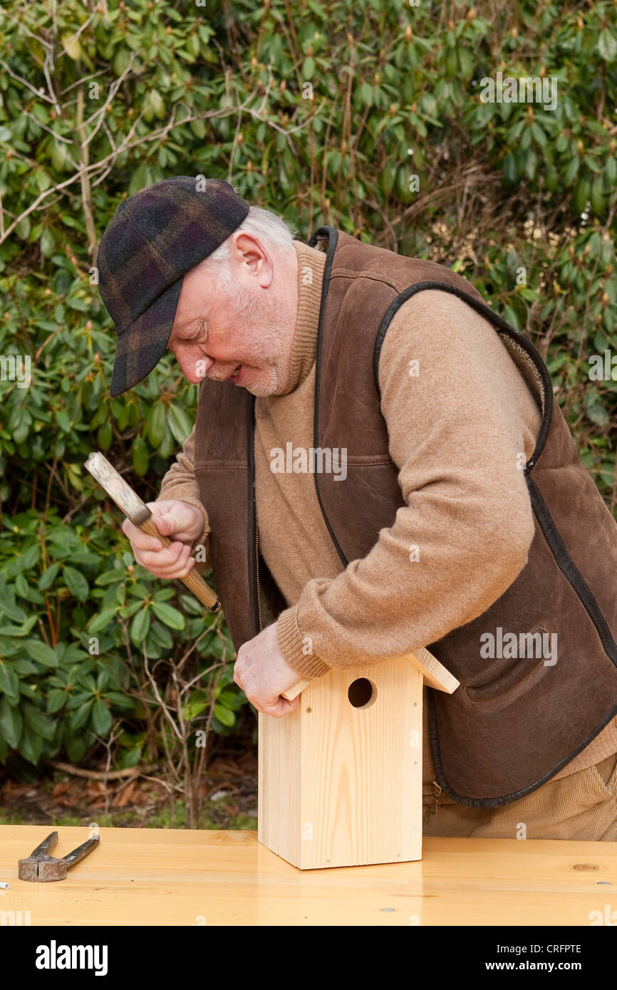 Elderly man building a nest box hi-res stock photography and images - Alamy