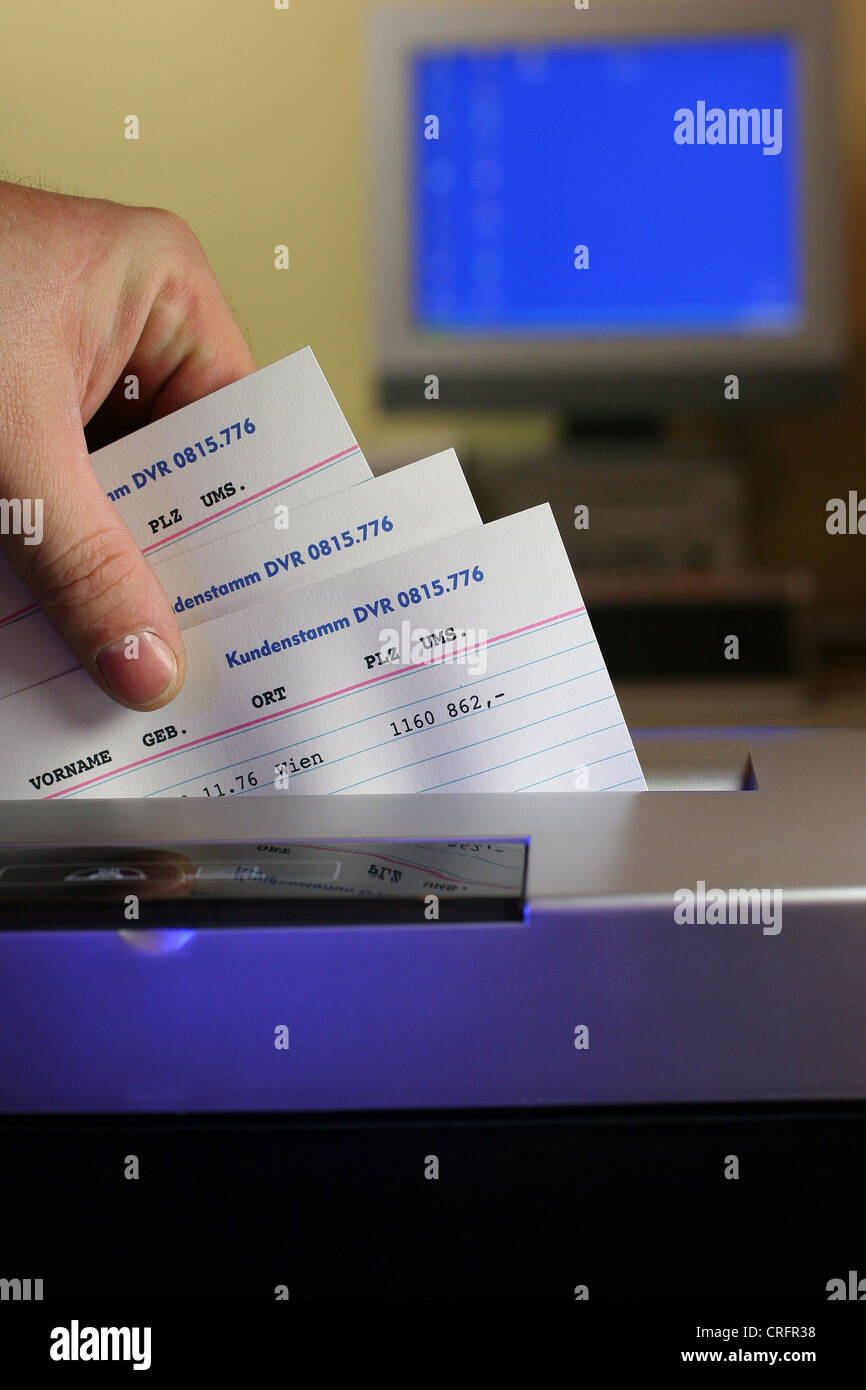 shredding machine and file card with customer data Stock Photo - Alamy