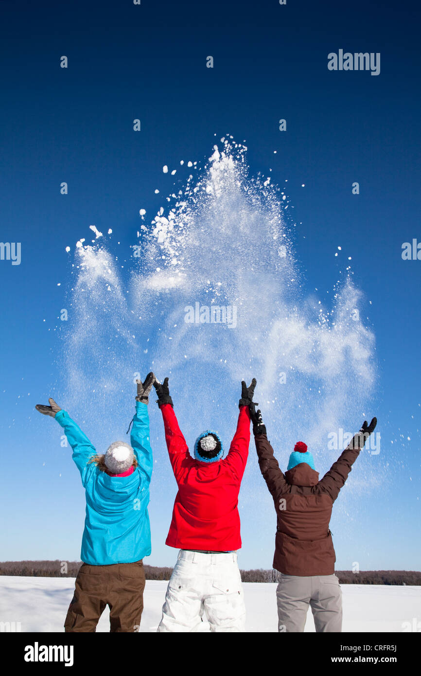 People playing with snow in field Stock Photo - Alamy