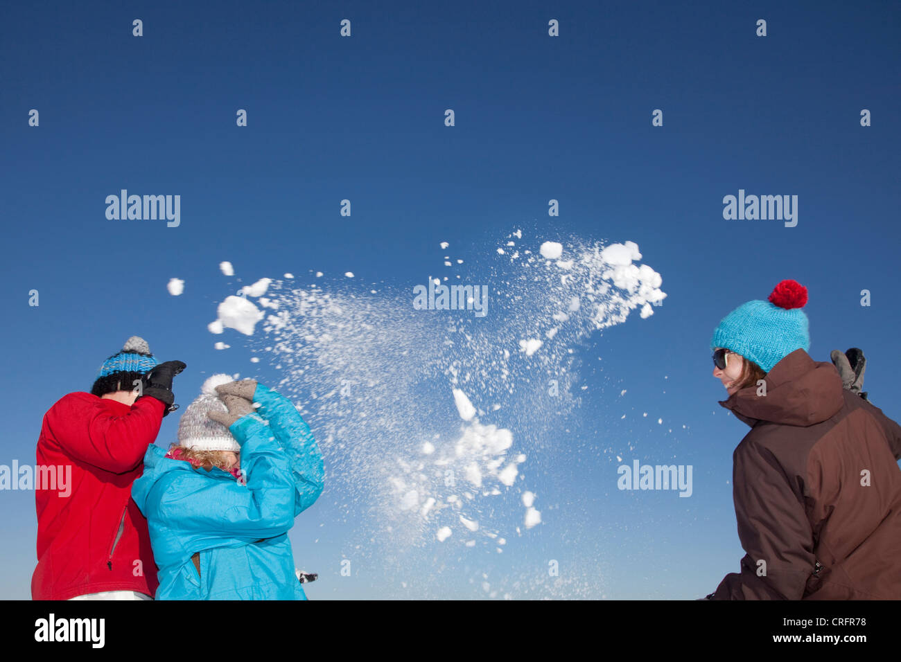 Friends having snowball fight outdoors Stock Photo - Alamy