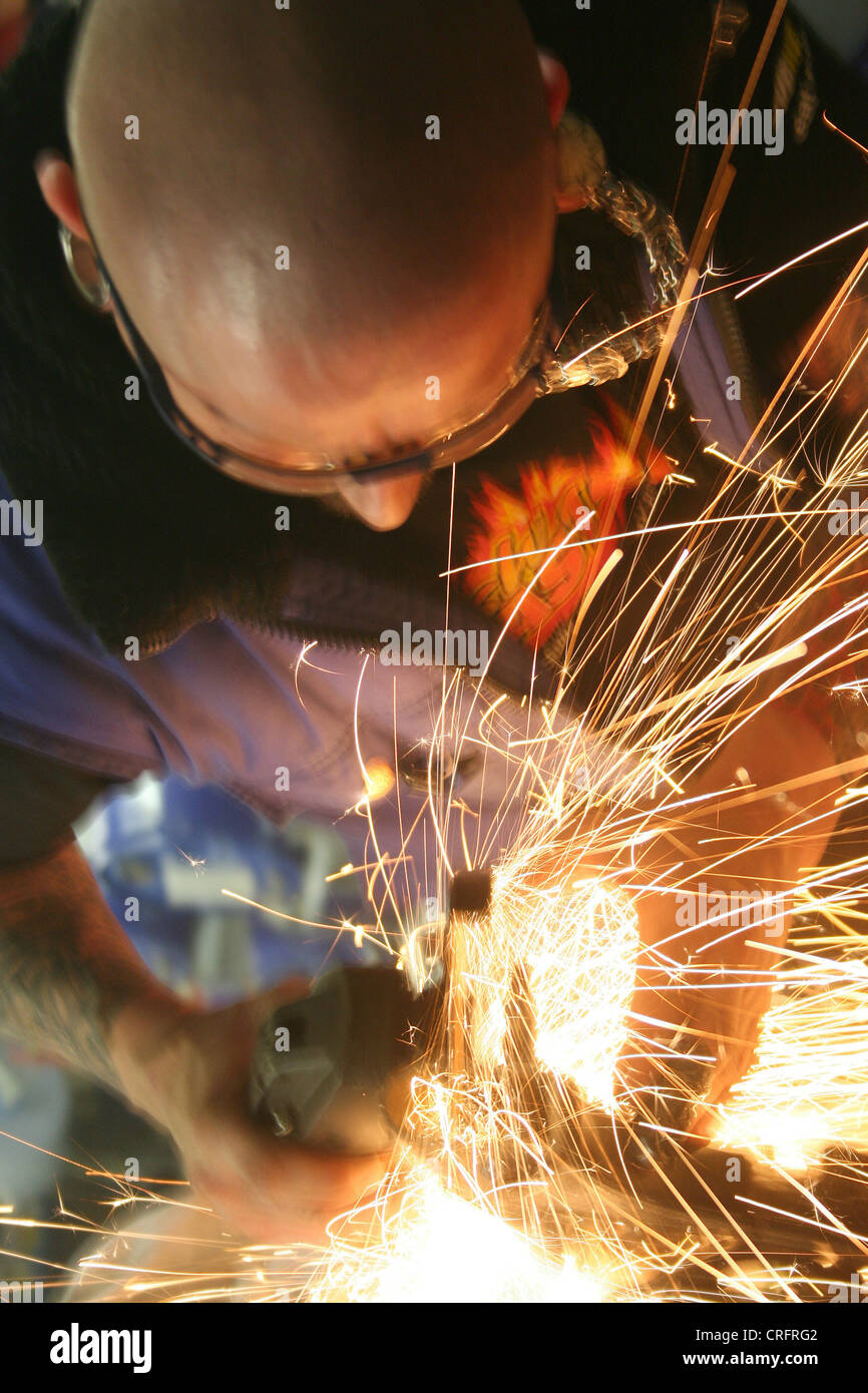 man grinding metal with angle grinder, metalworking Stock Photo - Alamy