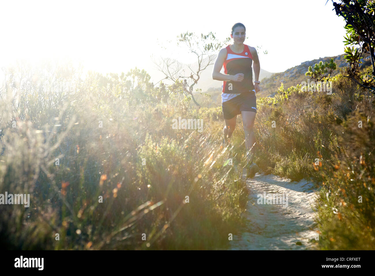 A woman trailrunning near Silvermine in Table Mountain National Park ...