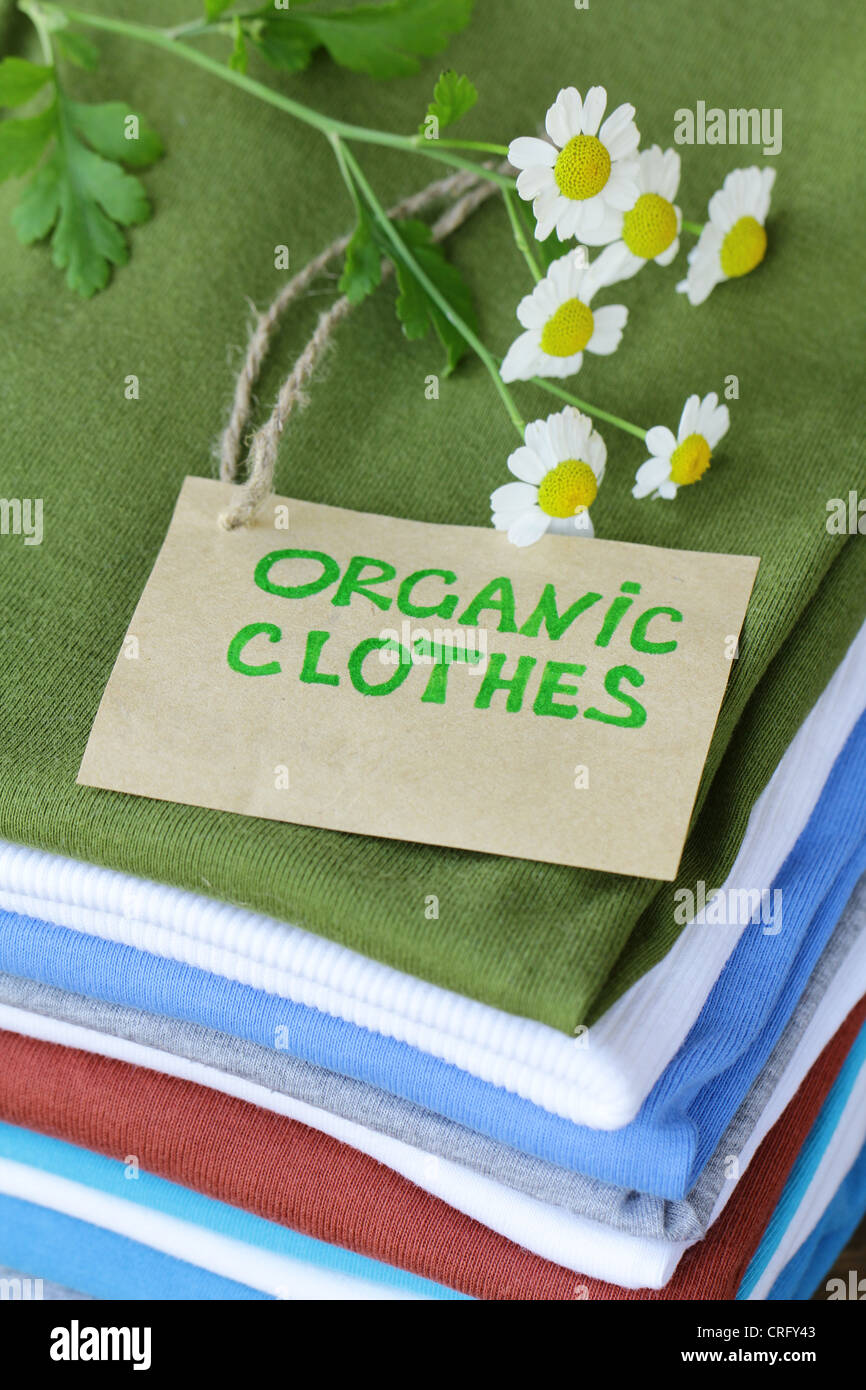 stack of colorful clothing with organic label Stock Photo - Alamy