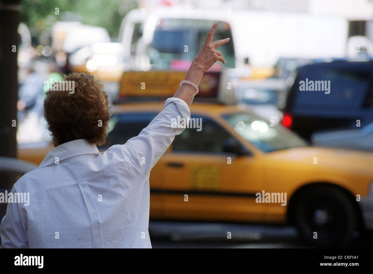 New York, USA, woman calls a yellow cab Stock Photo - Alamy