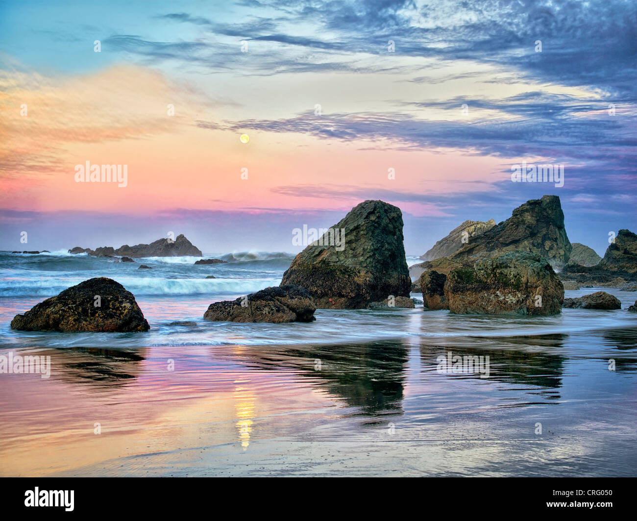 Sunrise and full moonset with reflection at Harris Beach State Park ...