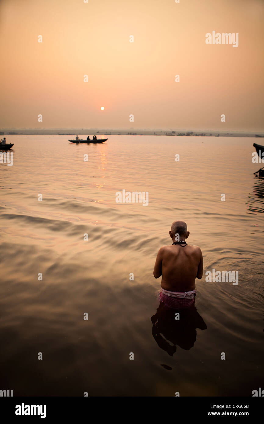 Hindu pilgrim pray in Ganga river within sunrise in Varanasi, Uttar ...