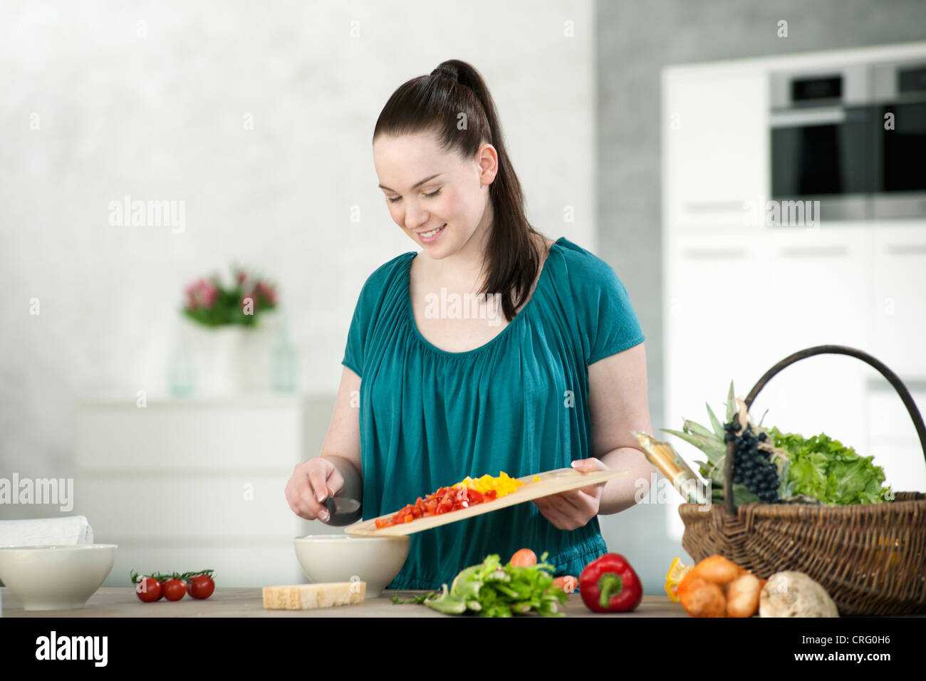 Woman chopping vegetables in kitchen Stock Photo - Alamy