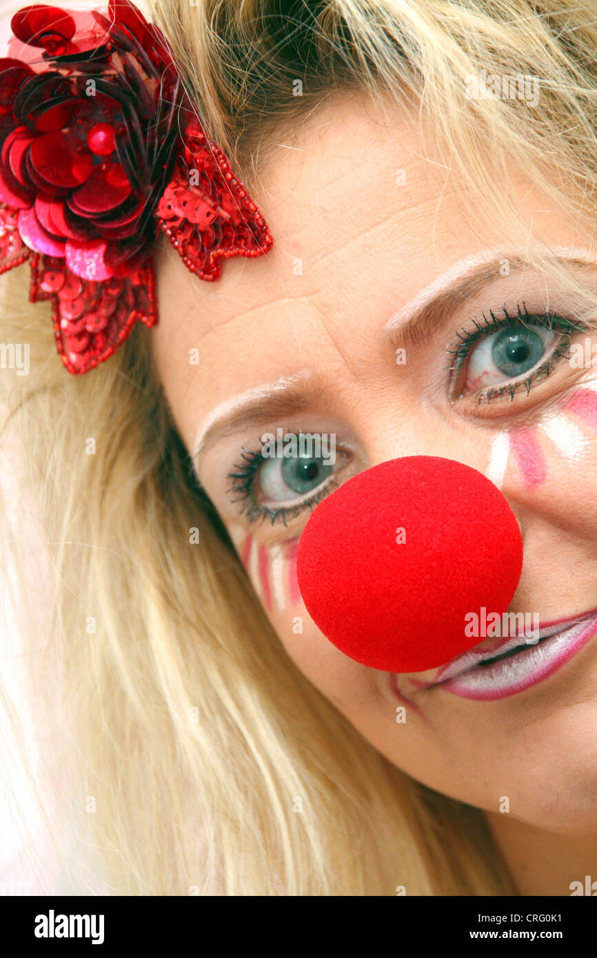rouged blond woman with red nose Stock Photo - Alamy