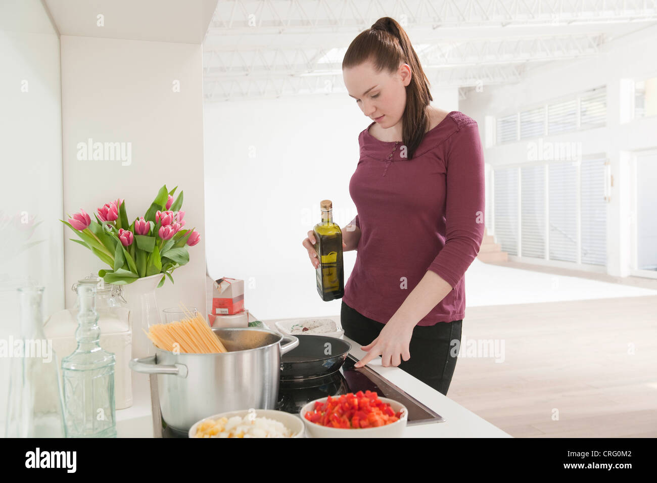 Woman cooking in kitchen Stock Photo - Alamy