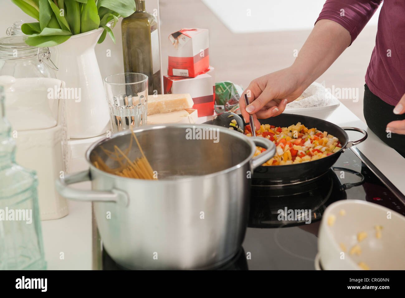Woman cooking in kitchen Stock Photo - Alamy