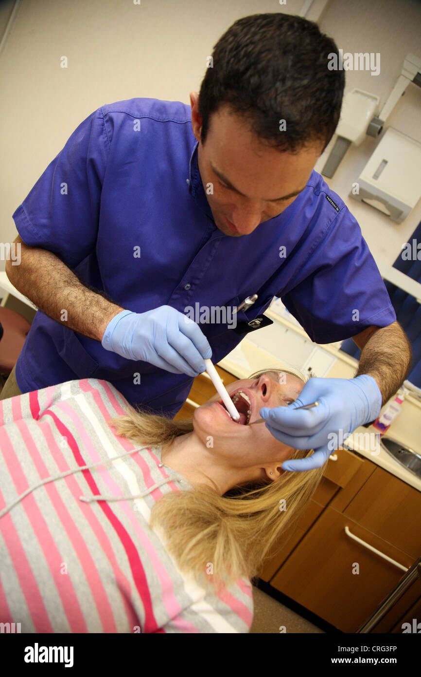 Dentist checking patients teeth Stock Photo - Alamy