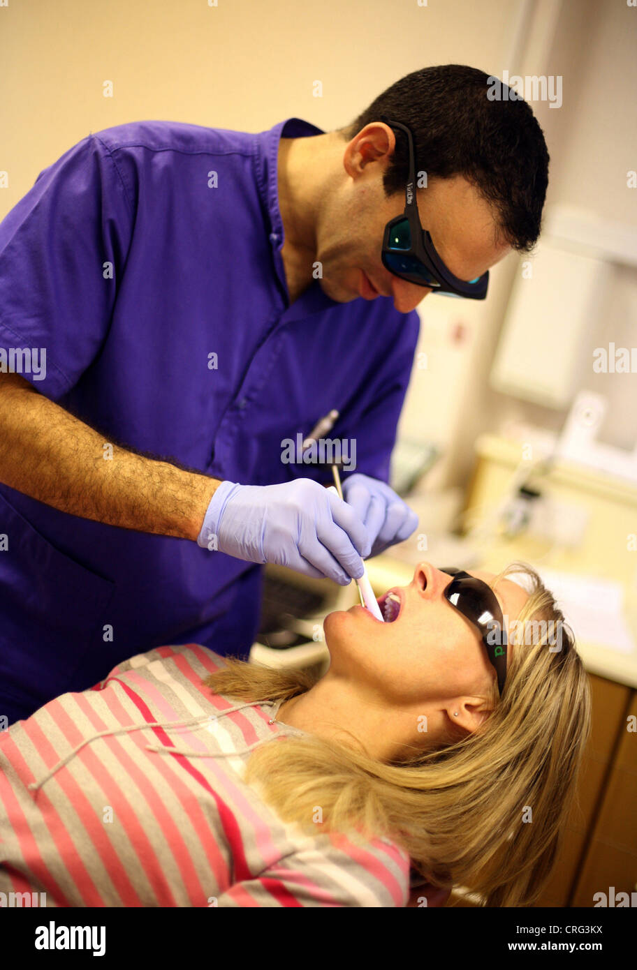 Dentist checking womans teeth Stock Photo - Alamy