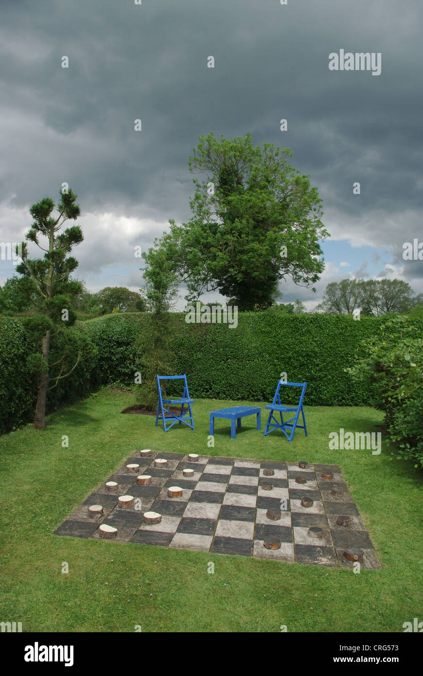 Giant draughts game, made of wood, set into a lawn in an English ...