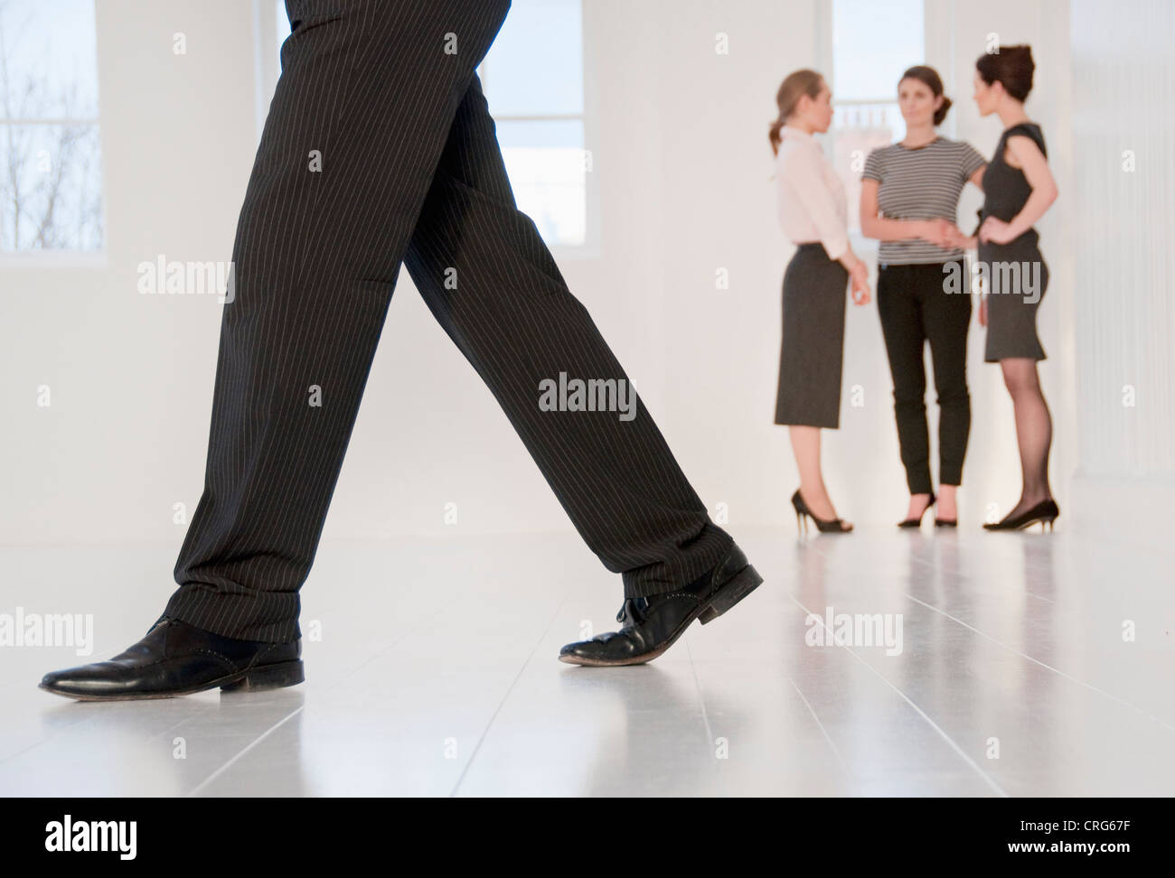 Businessmans feet walking in office Stock Photo - Alamy