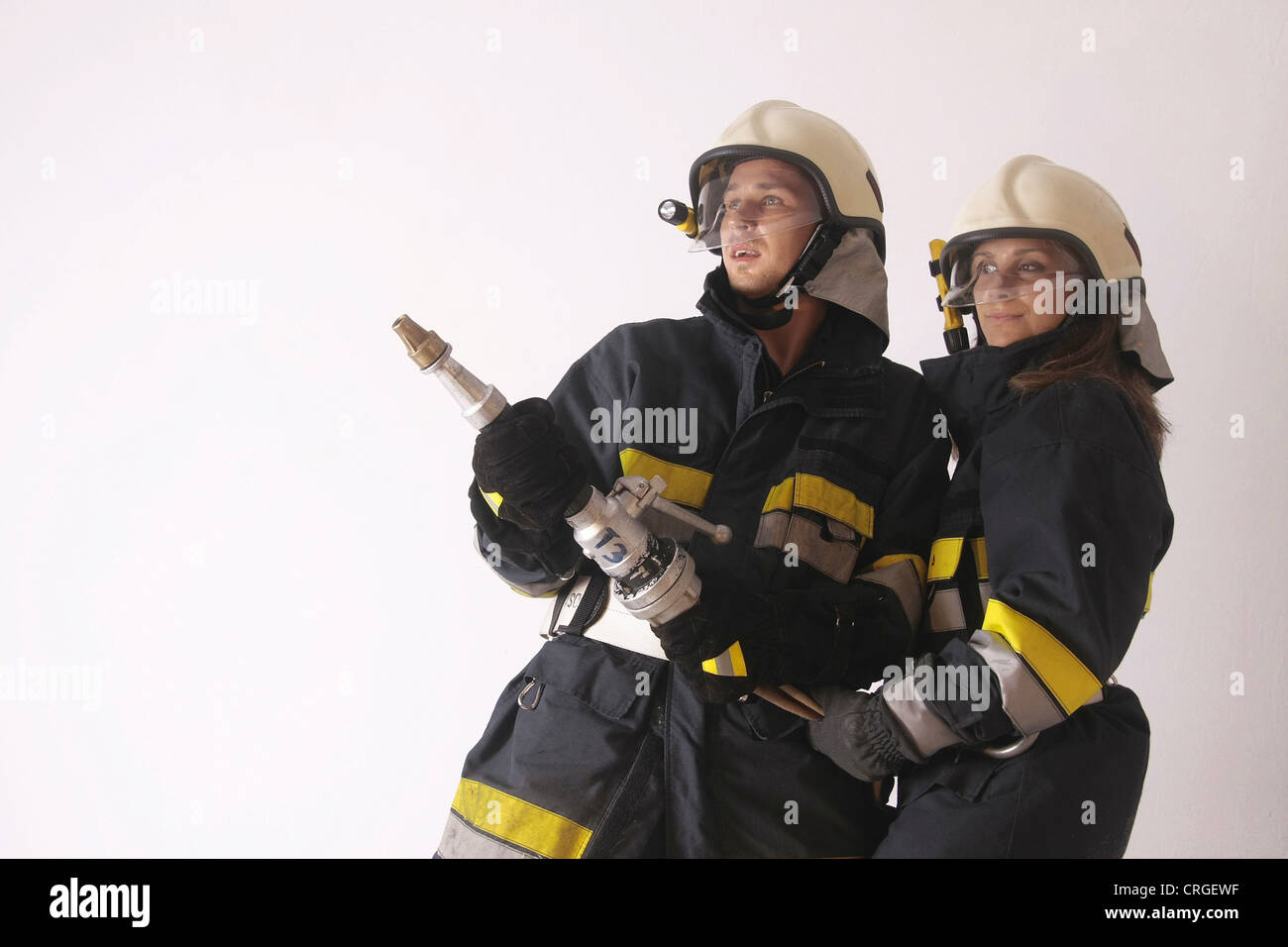 two firefighters with noozle Stock Photo - Alamy