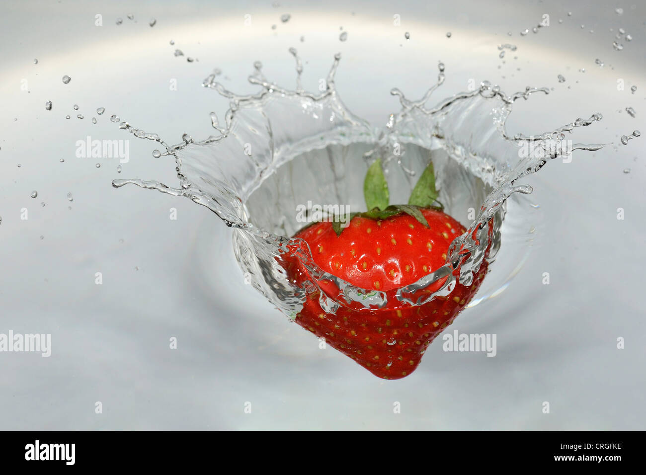 strawberry falling into water Stock Photo - Alamy