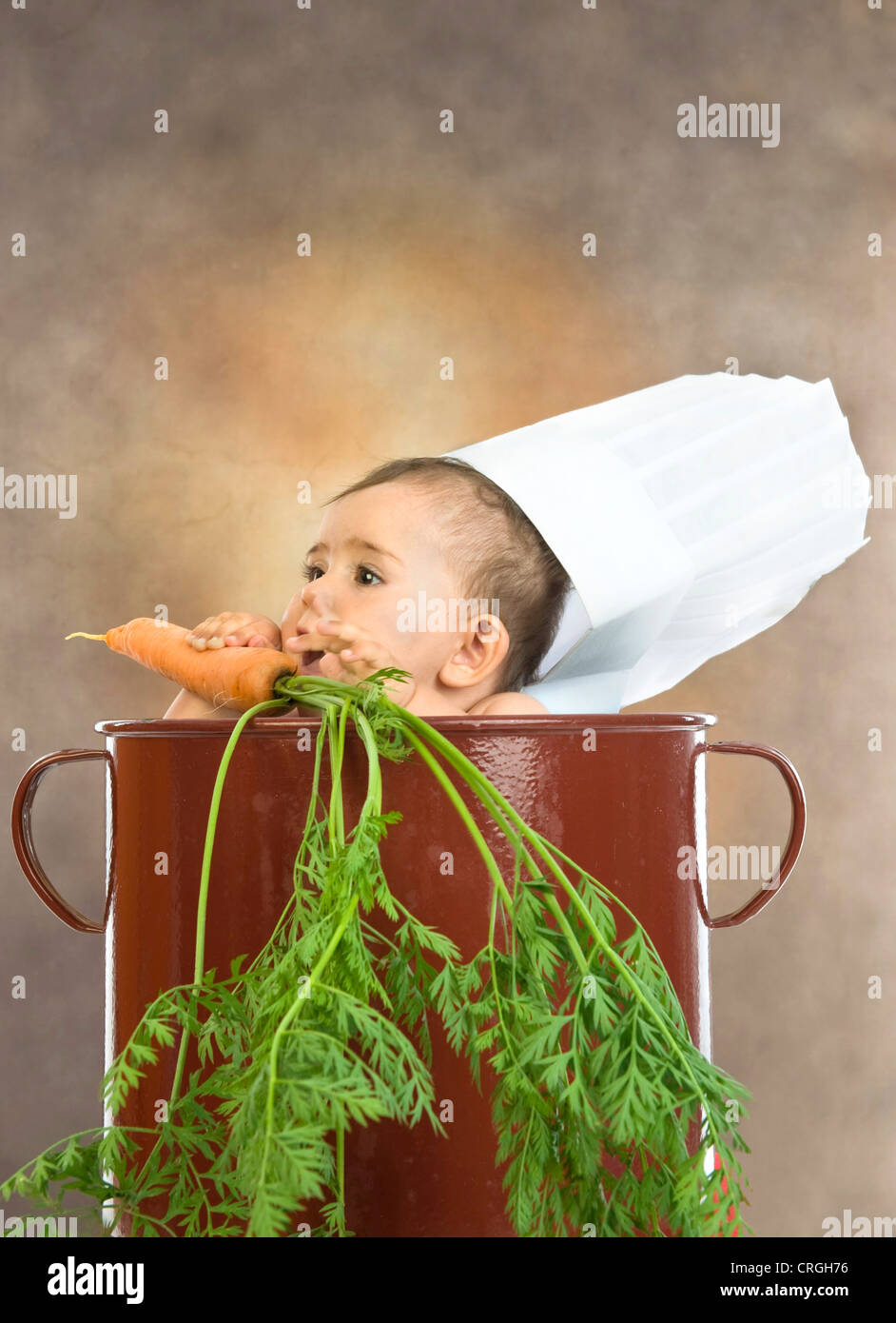 little child with chef's cap in cooking pot Stock Photo - Alamy