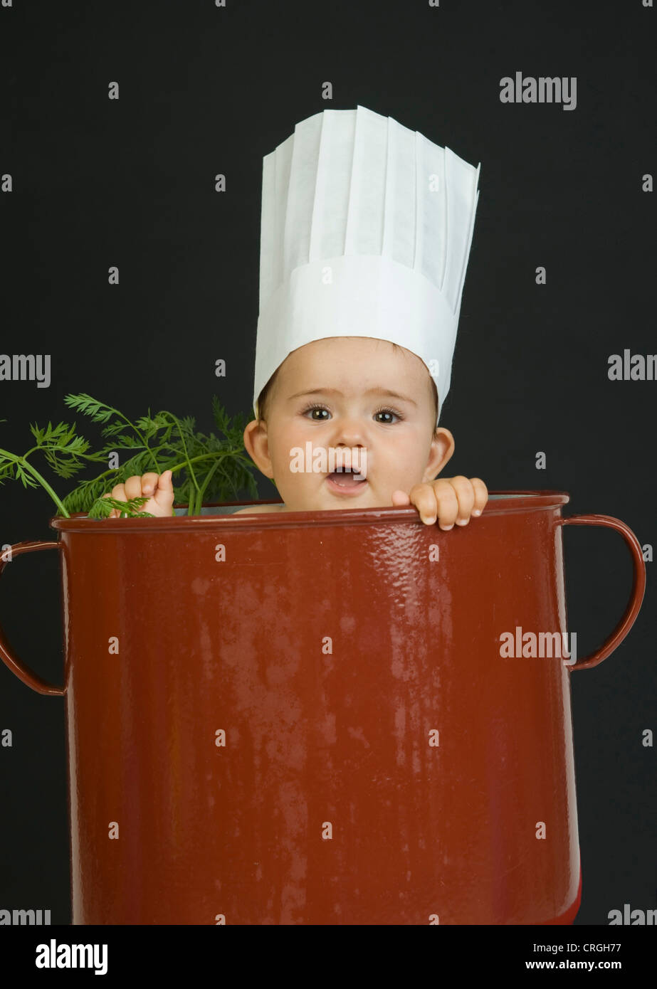 little child with chef's cap in cooking pot Stock Photo - Alamy
