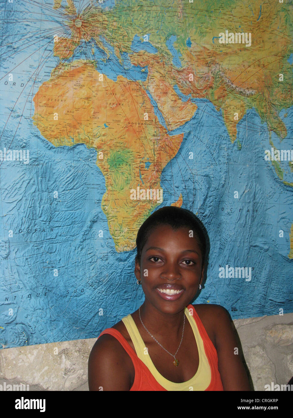 Young black woman sitting in front of African continent on worldmap ...