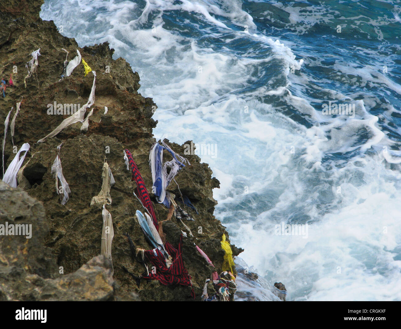 clothes washed onto the coast rocks by the sea surf, Haiti, Grande Anse ...